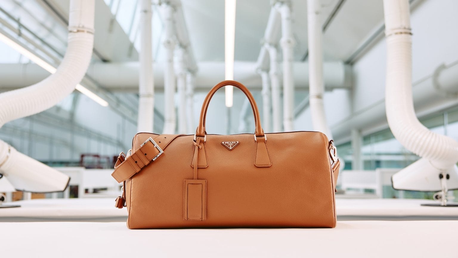 Refined Journeys Begin With The Prada Duffel Bag - LUXUO
